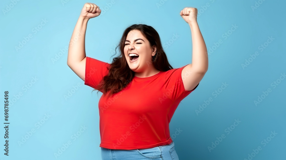 Portrait of a happy plus size woman in a red t-shirt on a blue ...