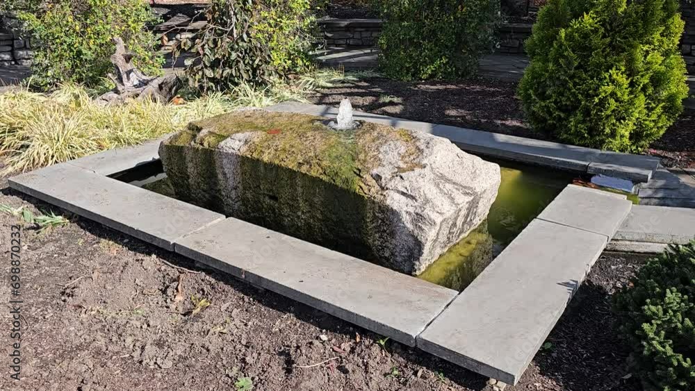 Stone water fountain with water bubbling out of rock center Stock Video ...