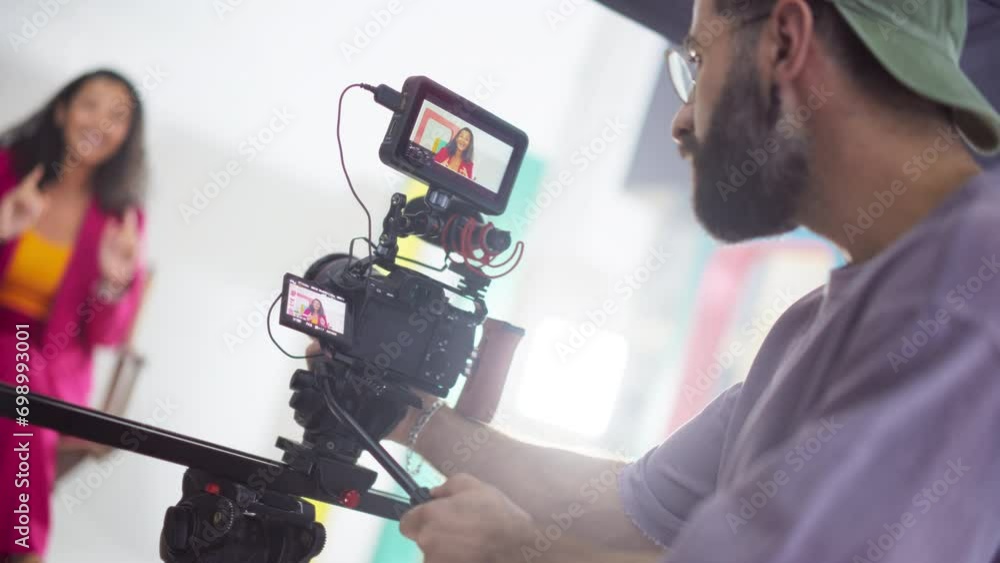 Close Up on Cameraman Filming a Female Tv Presenter in Colorful Clothes ...