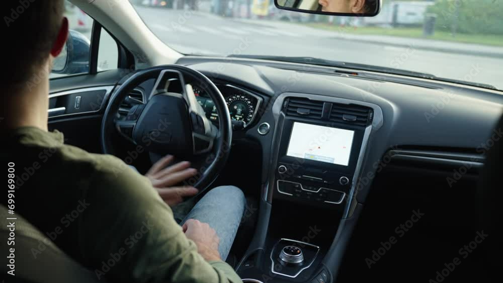 Male driver driving car, inside view. Rear view of man driving car in ...