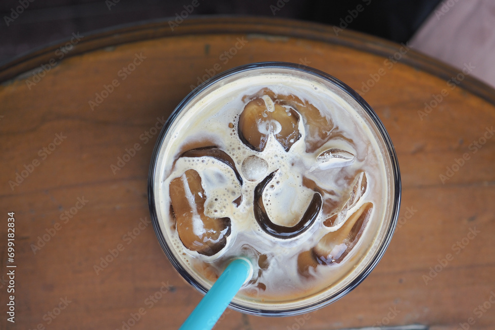top view of iced late in a transparent glass on cafe table outdoor Stock Photo | Adobe Stock