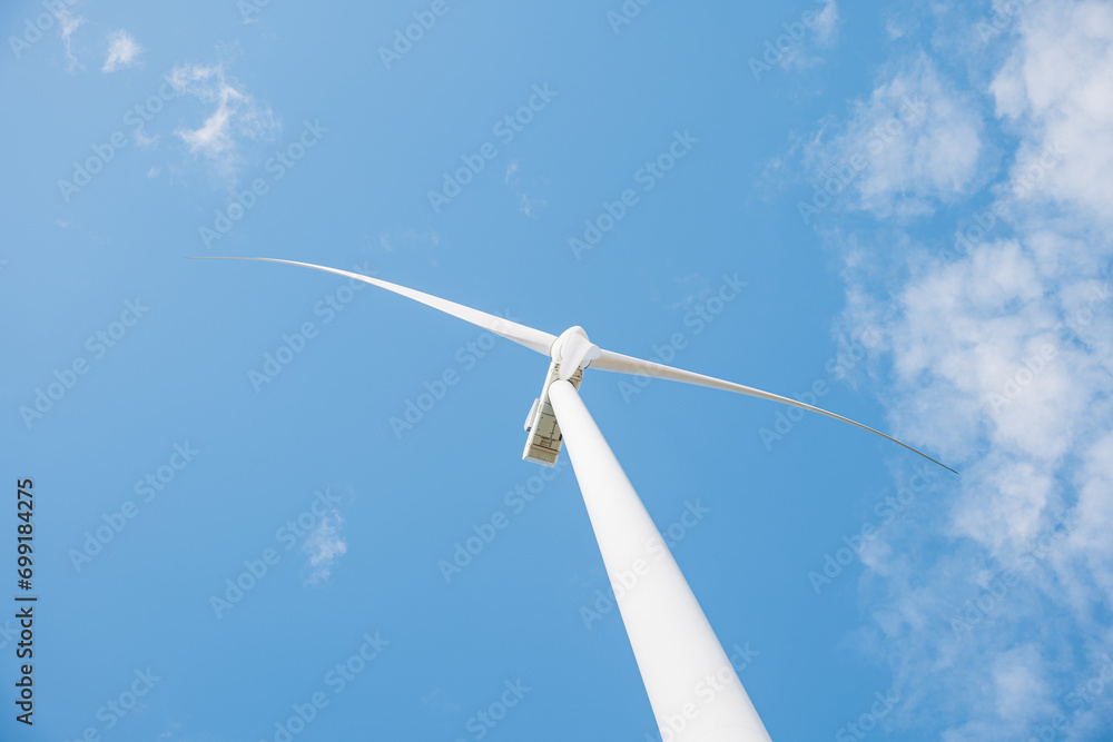 Atop a mountain windmill farm turbines illustrate efficient clean ...