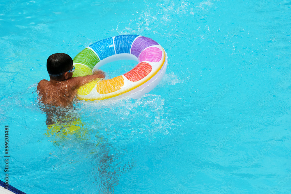 Little legs in the air; pool playtime at its best. Reflects the ...