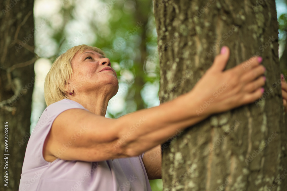 The woman s gentle hug to the tree exudes a sense of peace; a silent ...