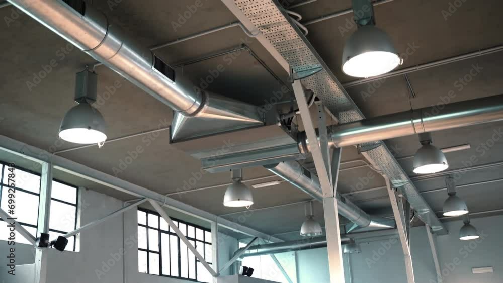 Installed ventilation system in modern loft space with big windows and ...