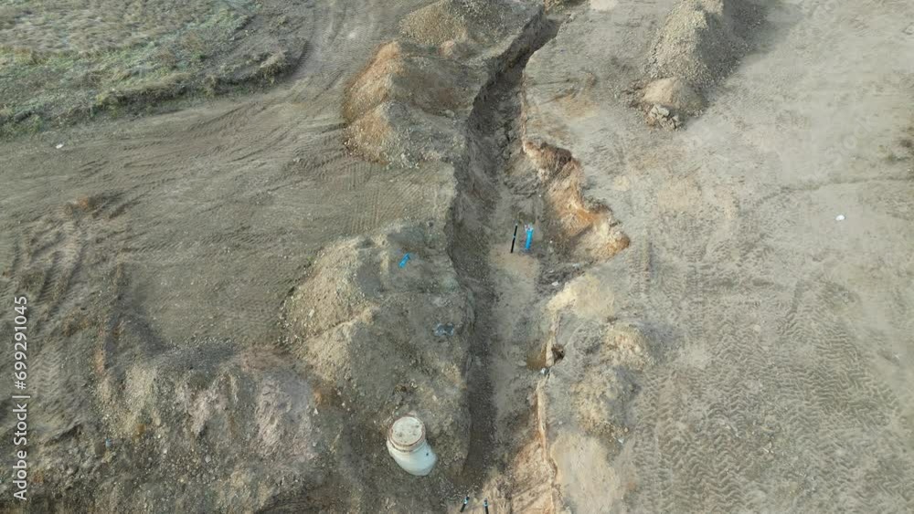 sewer excavations and piles of earth at the construction site ...