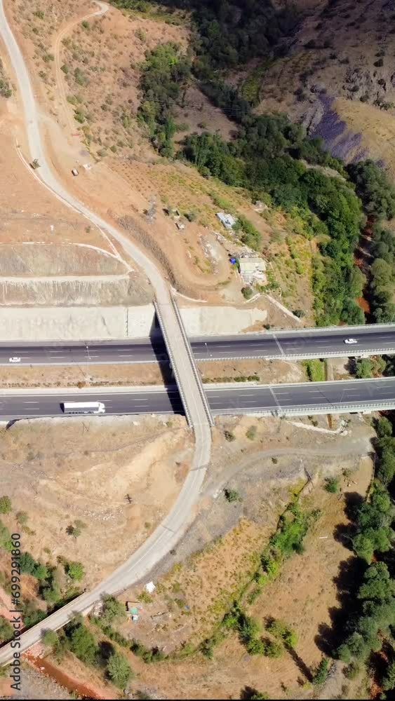 Mountain road features viaduct in scenic landscape. Aerial view of ...