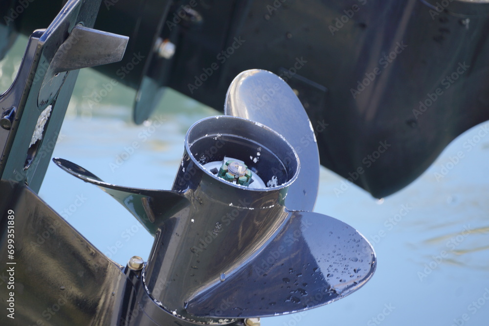 Black shiny boat propeller with water droplets on it, water in ...