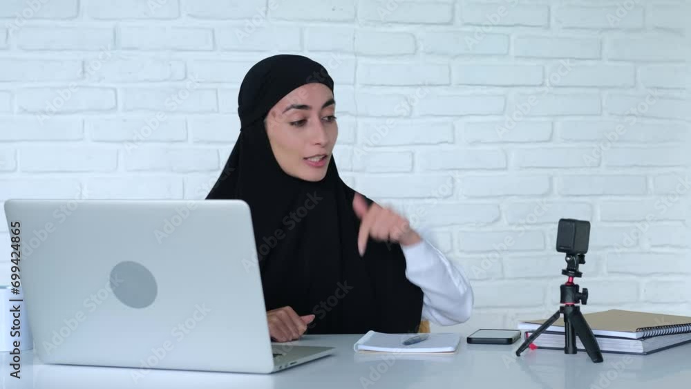Muslim woman ends video call on smartphone. Medium shot: Muslim woman ...