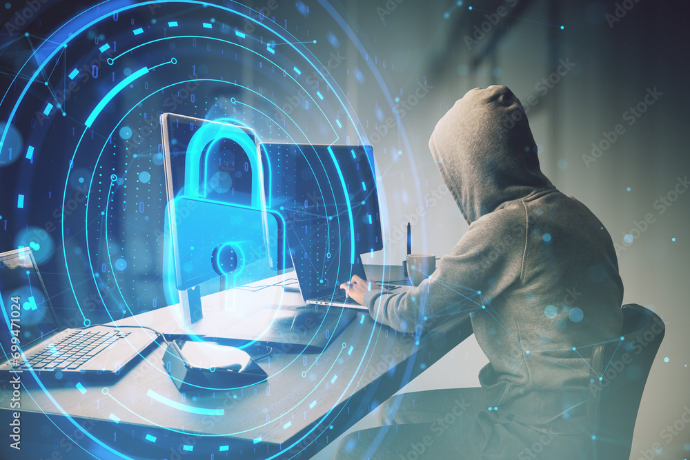 Hacker at desk using laptop with creative round digital padlock ...