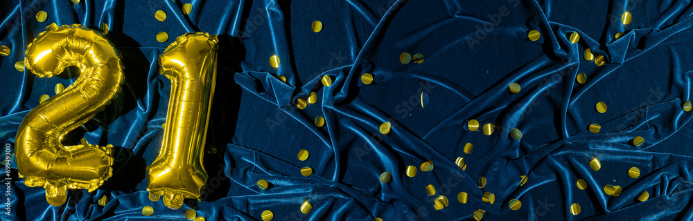 number twenty one, gold foil balloon number on blue velvet background ...