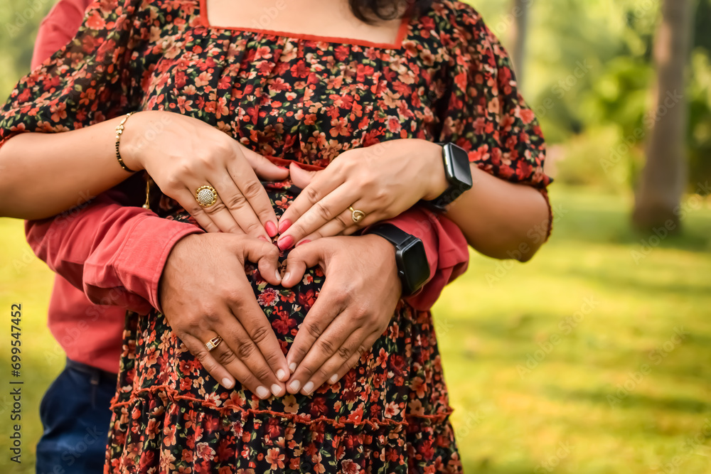 Indian couple posing for Maternity shoot pose for welcoming new born ...