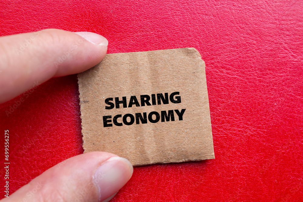 Sharing economy lettering on ripped cardboard paper piece with red ...