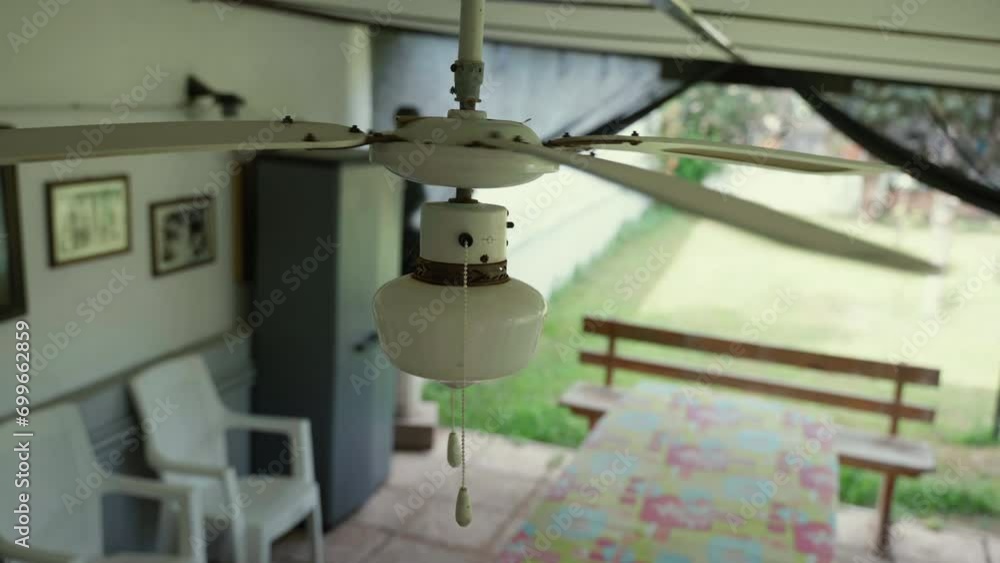 Person hand turning on ceiling fan pulling chain down, old electric ...