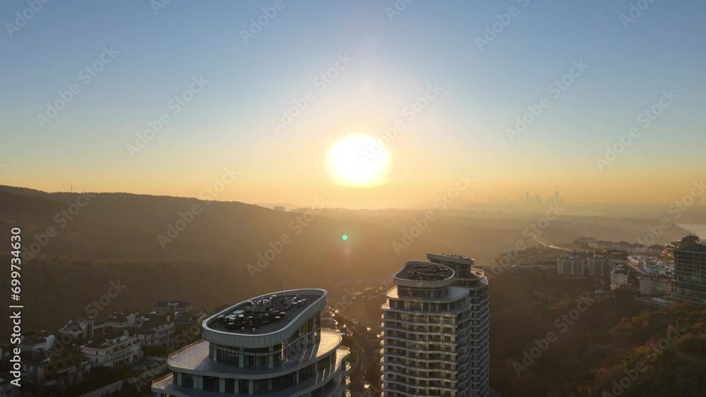 High altitude footage of a drone going backwards between skyscrapers to ...