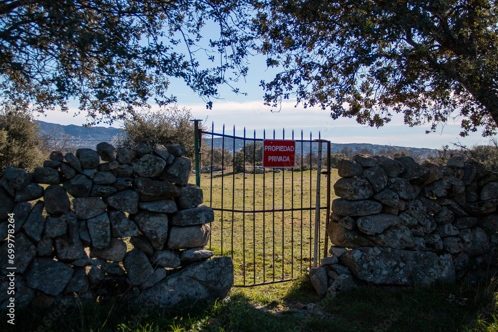 Translation: Private property. Private property sign Iron bar gate on a ...