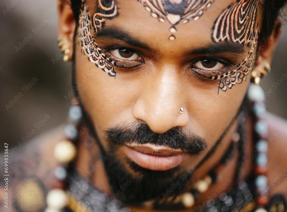 Indigenous person with traditional necklaces, body painting and tattoos ...