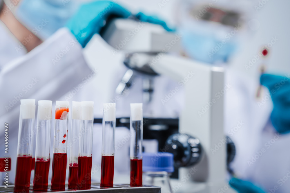 Professional scientists in lab working with blood samples. to find ...