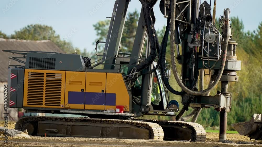 Drilling water wells. Machine lowers drill down. Slow motion. Closeup ...