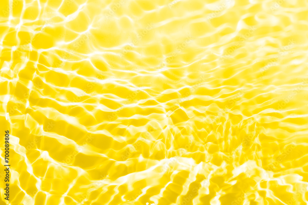 Yellow water with ripples on the surface. Defocus blurred transparent ...