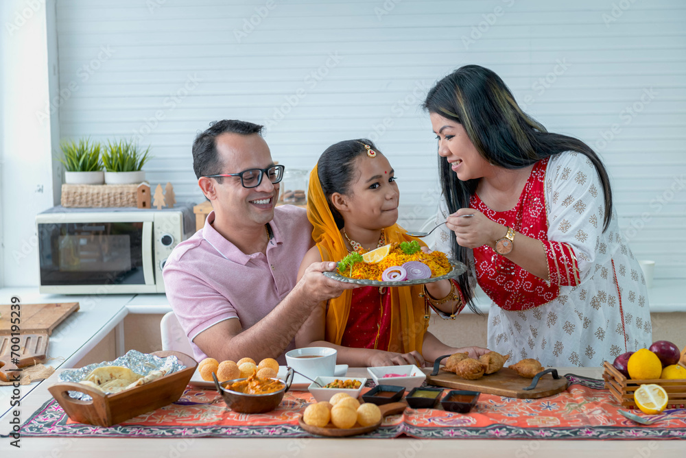 Indian family sitting in the kitchen They are looking and preparing ...