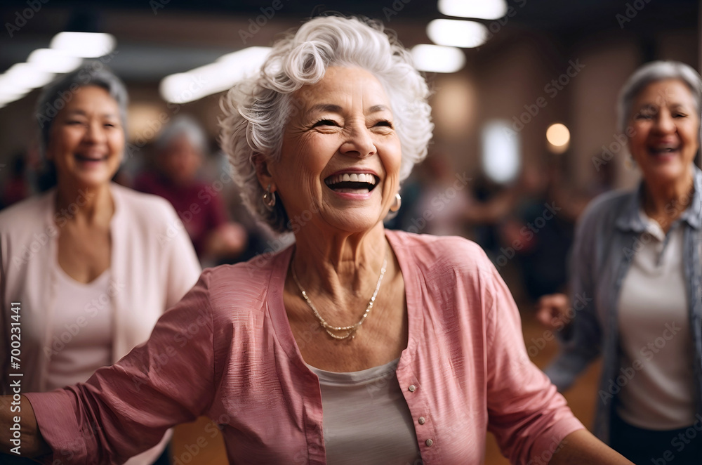 Obraz Senior woman dancing in a group dance class, leading active and ...