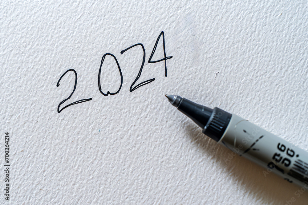 2024 Happy New Year date handwritten in a text script with a black ...