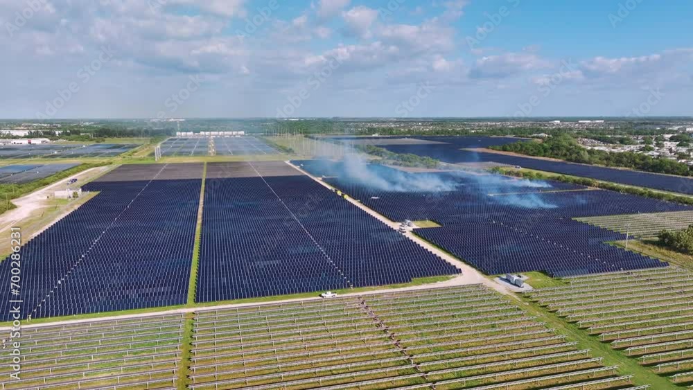 Dangerous wild fire at sustainable electric power plant with many rows ...