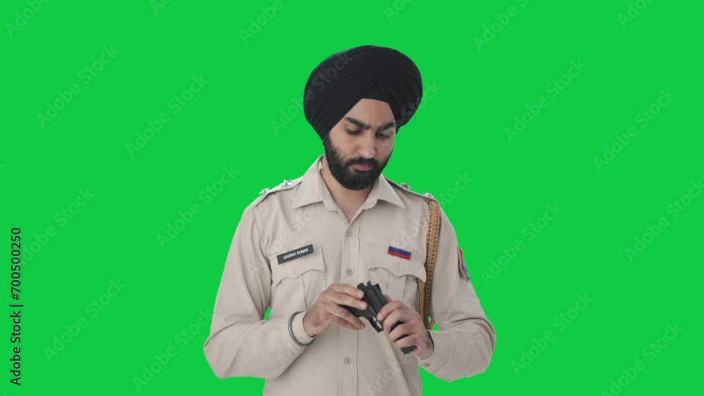 Sikh Indian police man checking hand gun Green screen Stock Video ...