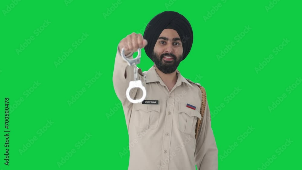 Happy Sikh Indian police man posing with handcuffs Green screen Stock ...