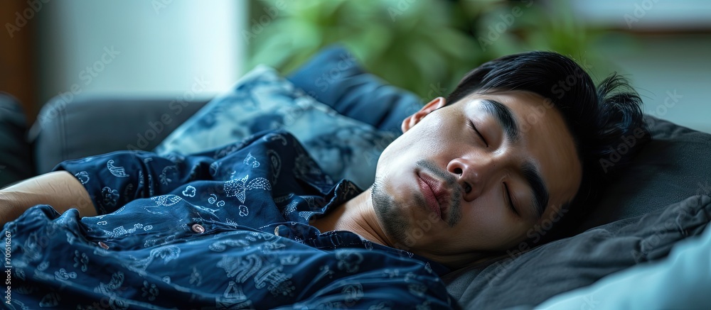 Asian man take a nap on sofa with snore take nap daydreaming in living ...