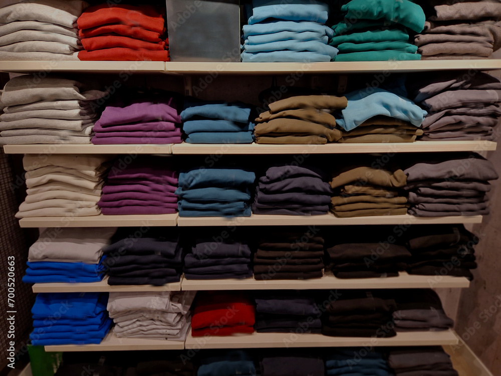 the wardrobe with shelves is clearly divided by color and type of ...