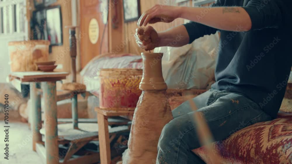 Potter at work. Potter's hands covered with clay making beautiful vase ...