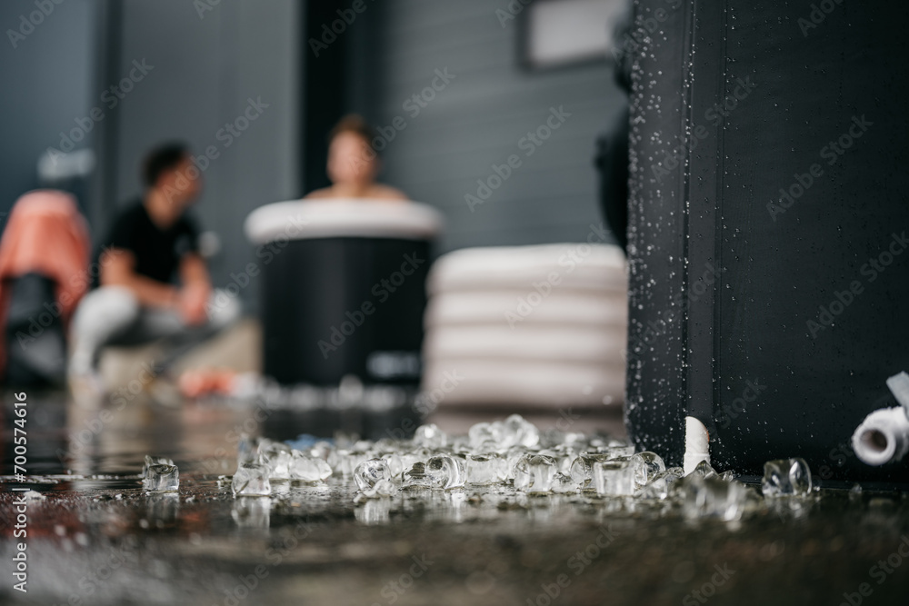 Ice blocks fallen out of ice bath with blurry people in background ...