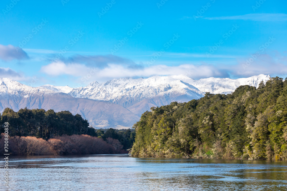 Photograph of snow capped mountains and flood waters in the Waiau River ...