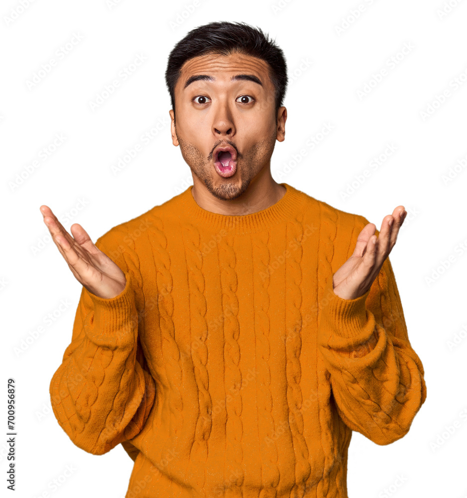 Young Chinese man in studio background surprised and shocked. Stock ...
