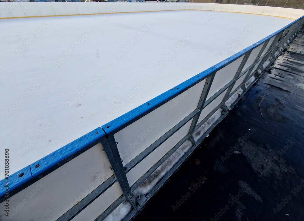 hockey field with goalposts and yellow lines around perimeter. plastic ...