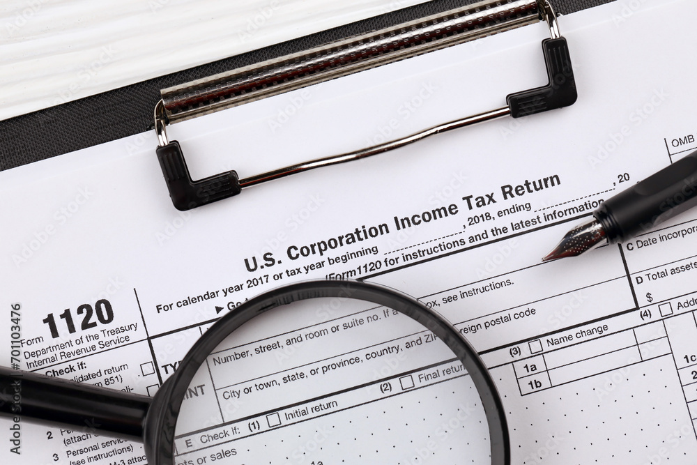 IRS Form 1120 US Corporation income tax return blank on A4 tablet lies ...