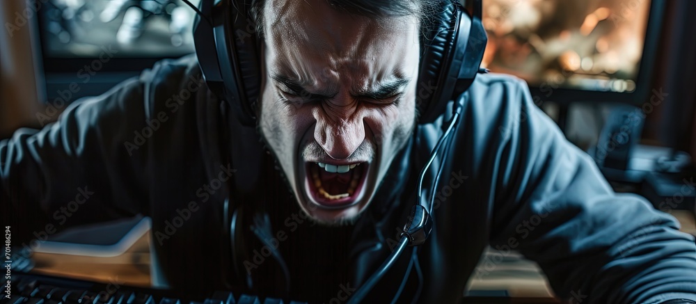 Medium shot of an angry gamer destroying keyboard after losing a match ...