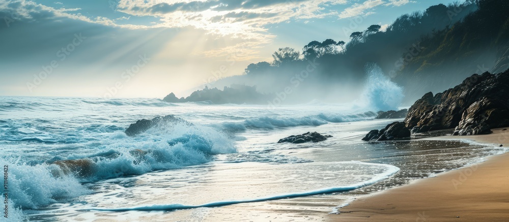 Mysterious shore of sea in early morning in calm weather with soft haze ...