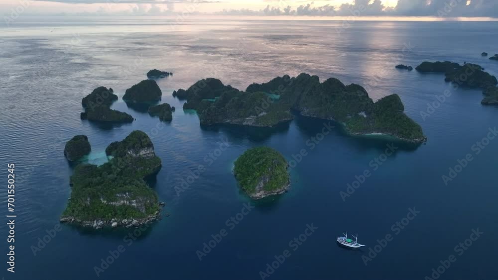 Rugged, limestone islands rise from the impressive seascape in Misool ...
