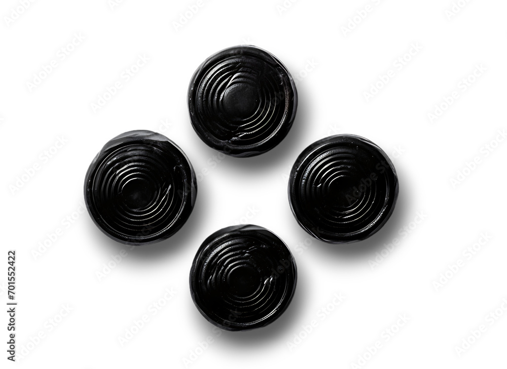 Top view, close up of four round black licorice candies isolated on ...