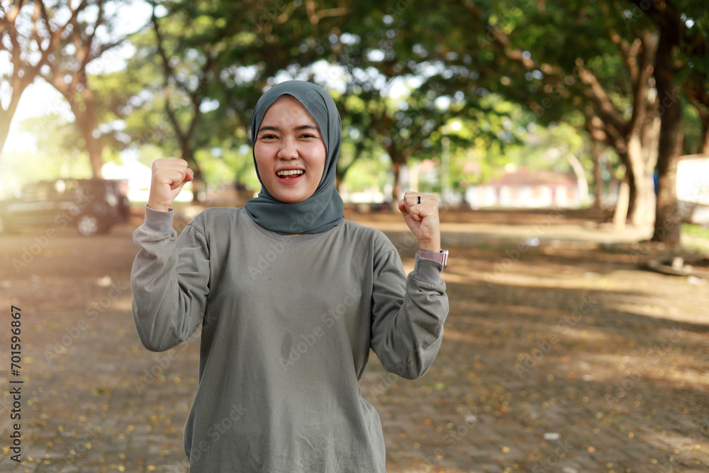 Portrait fit asian muslim female fitness runner joyful and excited ...