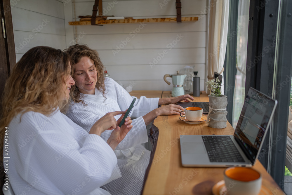 Girls working at laptops at same table distracted by conversation, chat ...