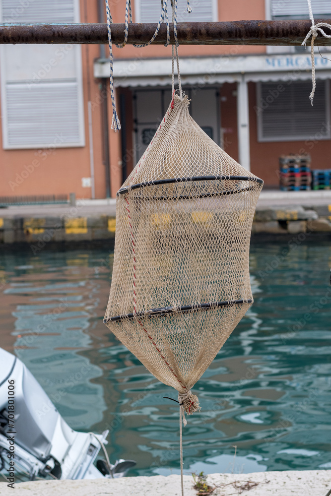 Items for fishing set found on the port of Grado. Typical keepnet that ...