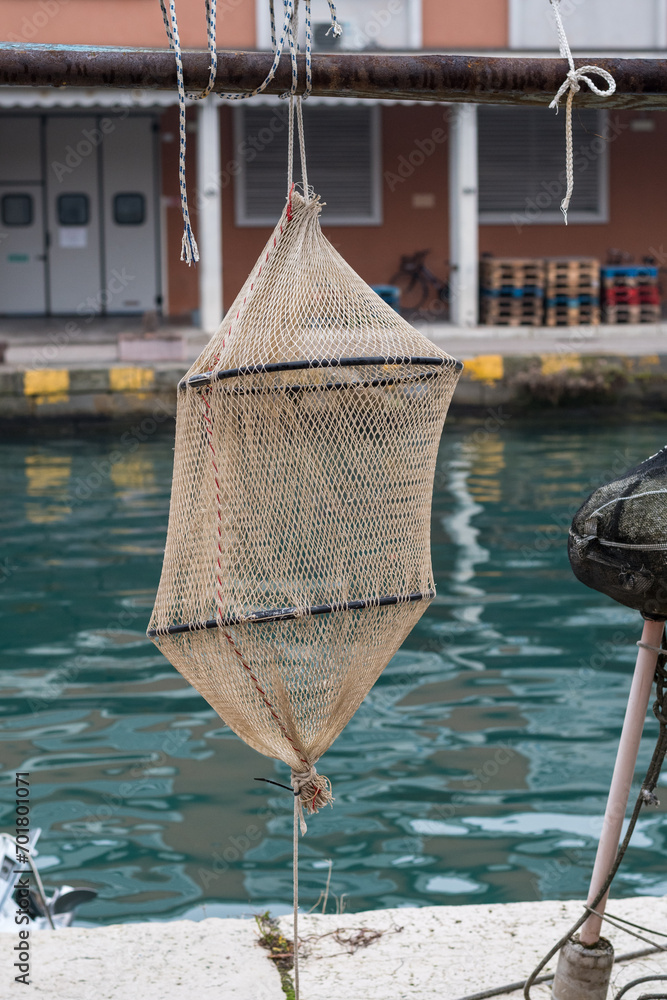 Items for fishing set found on the port of Grado. Typical keepnet that ...