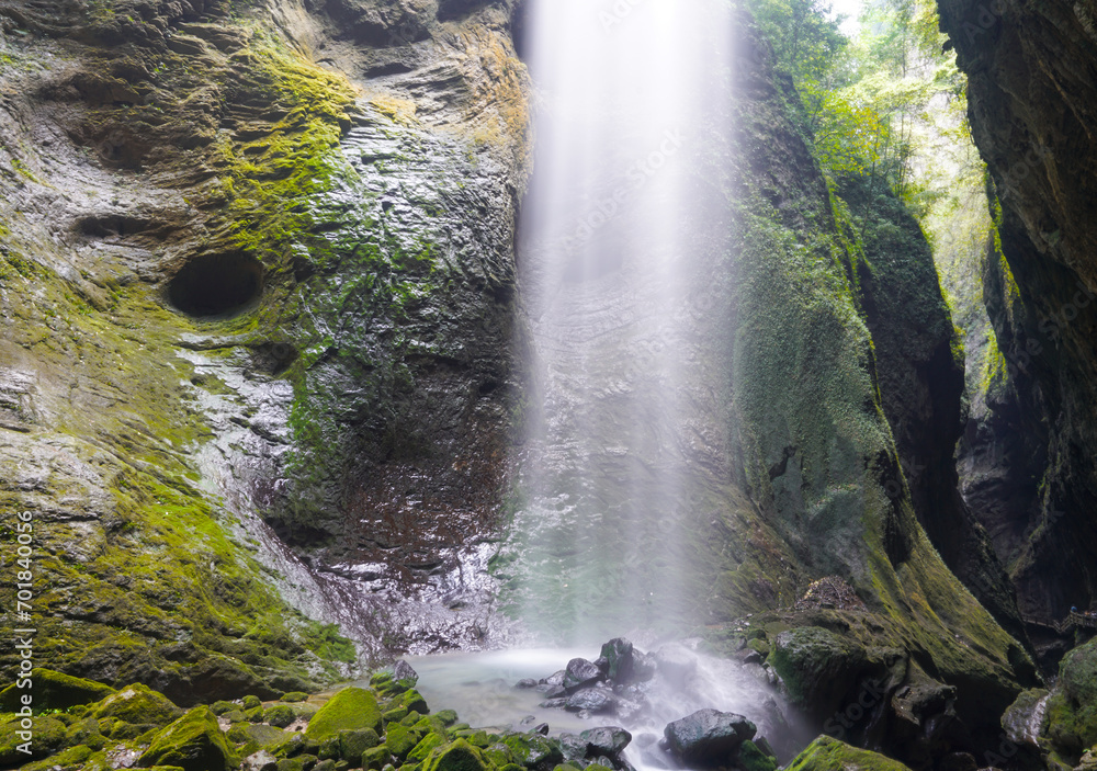 Waterfalls in the canyon fall from the sky. Like a silver-white chain ...