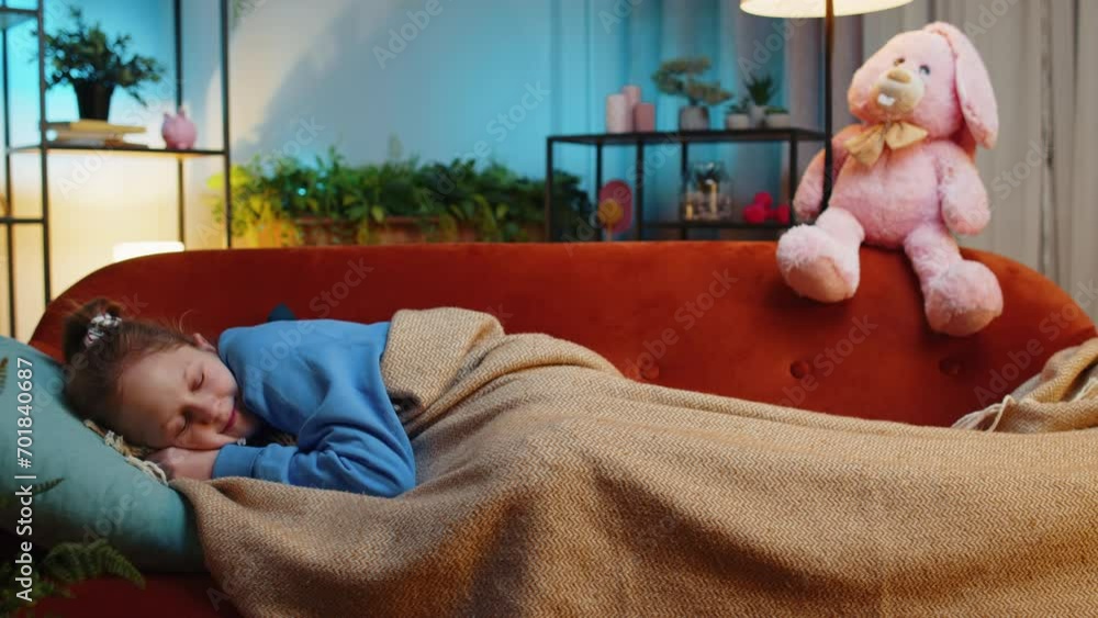 Tired preteen child girl lying down in bed taking a rest at home ...