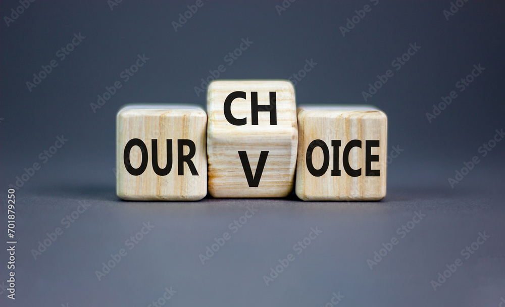 Our voice choice symbol. Businessman turns wooden cube and changes ...