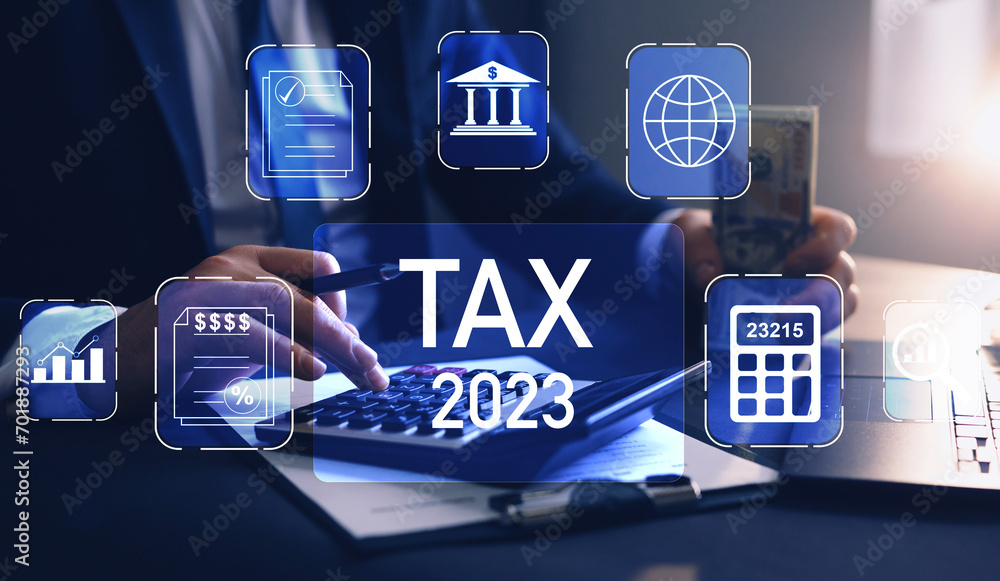 Businessman using the laptop to fill in the income tax online return ...